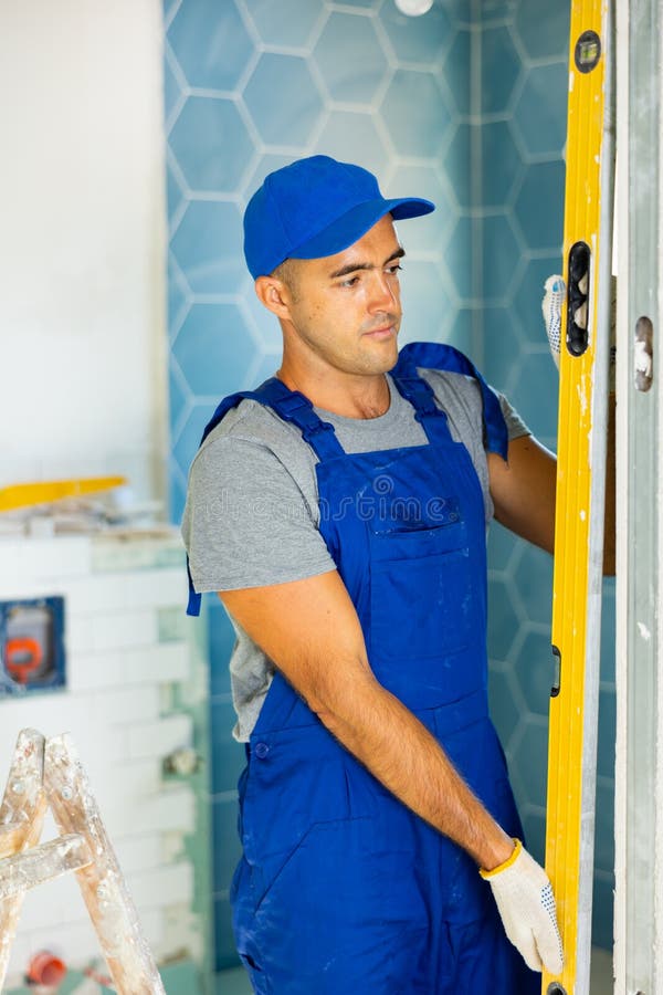 Master Wearing Work Clothes Checking Vertical of Installing Tiles Using ... Master Wearing Work Clothes Checking Vertical of Installing Tiles Using ...