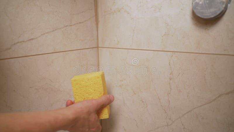 The Ceramic Tile Laying Master Wipes the Seams with a Special Sponge ...