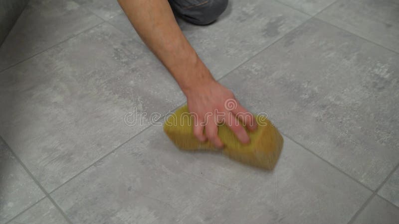 Workers Wipe the Seams between the Tiles with a Wet Sponge. Finishing ...