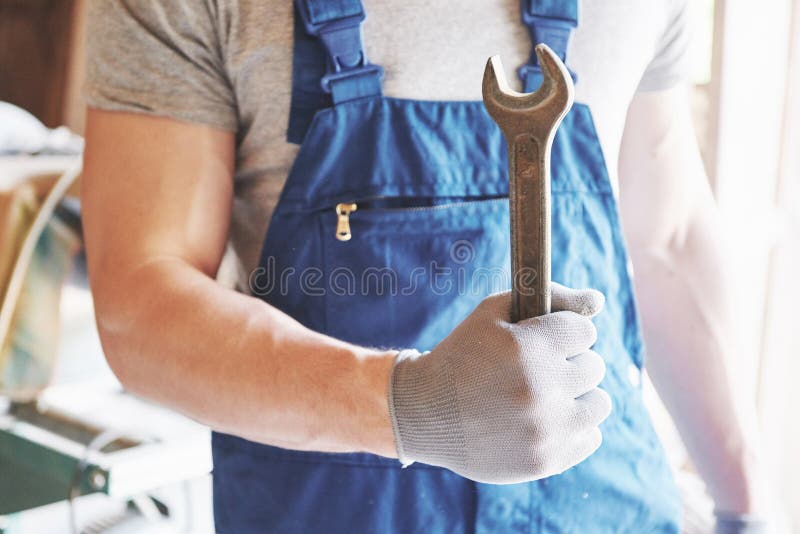 Master in Working Form and Gloves with a Key in His Hands. Stock Photo ...