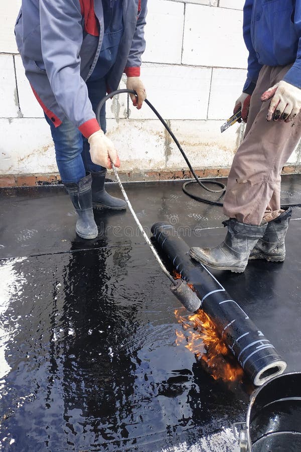The Master Works with the Assistant To Work on the Waterproofing of the ...