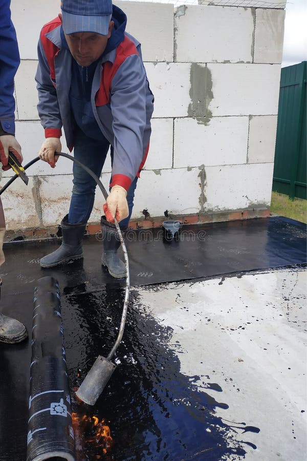 The Master Works with the Assistant To Work on the Waterproofing of the ...