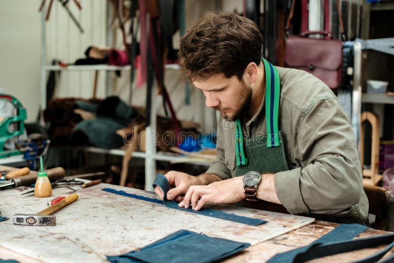 A Master Works with Genuine Leather in the Workshop Stock Photo - Image ...