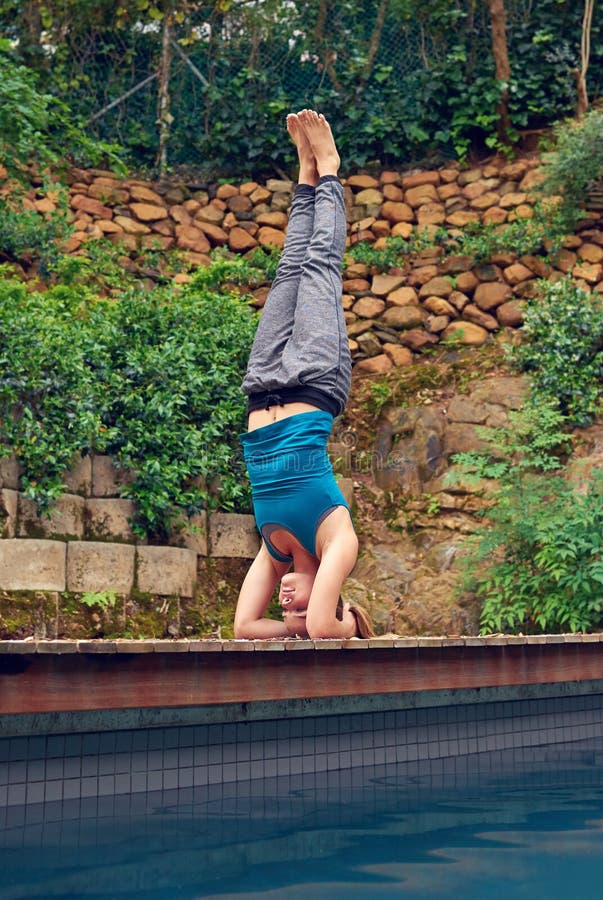 Mastering Her Mind and Body. a Young Woman Practicing Yoga Outdoors ...