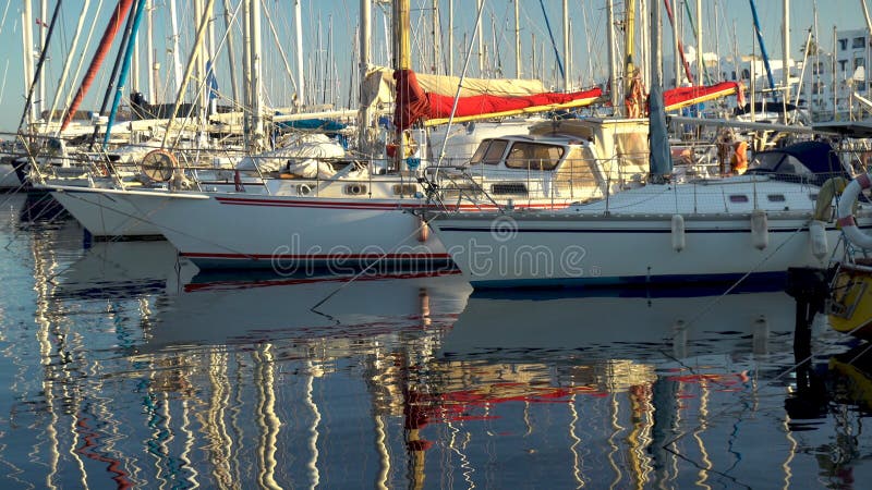 Masts of Ships are Reflected in the Water. Modern Ships are in the Bay ...