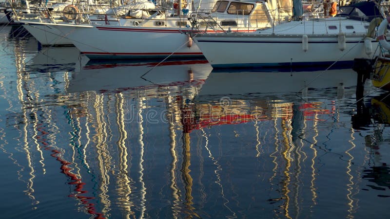 Masts of Ships are Reflected in the Water. Modern Ships are in the Bay ...