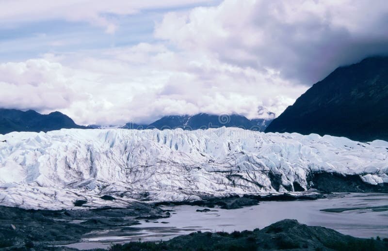 Matanuska Glacier between Mountain Range Stock Photo - Image of clouds ...