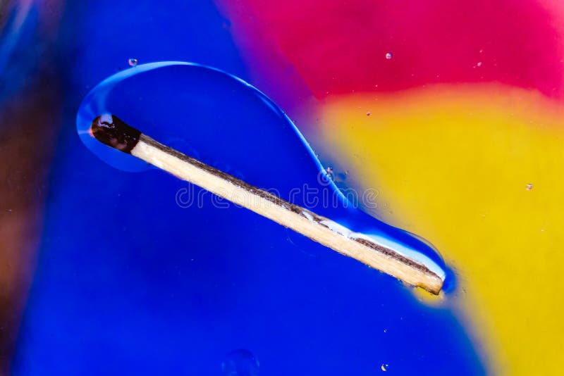 Match in a Colorful Background of Water and Oil Drops Stock Image ...