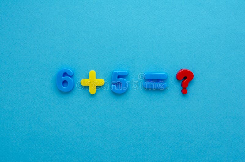 Math Action from Colored Plastic Numbers on Blue Paper Background Stock ...