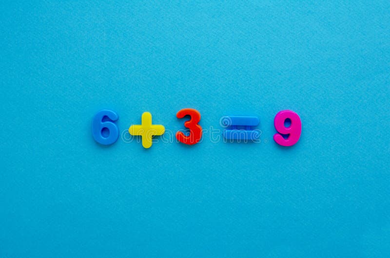 Math Action from Colored Plastic Numbers on Blue Paper Background Stock ...