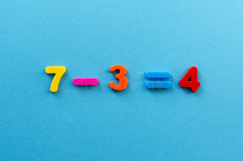 Math Action from Colored Plastic Numbers on Blue Paper Background Stock ...