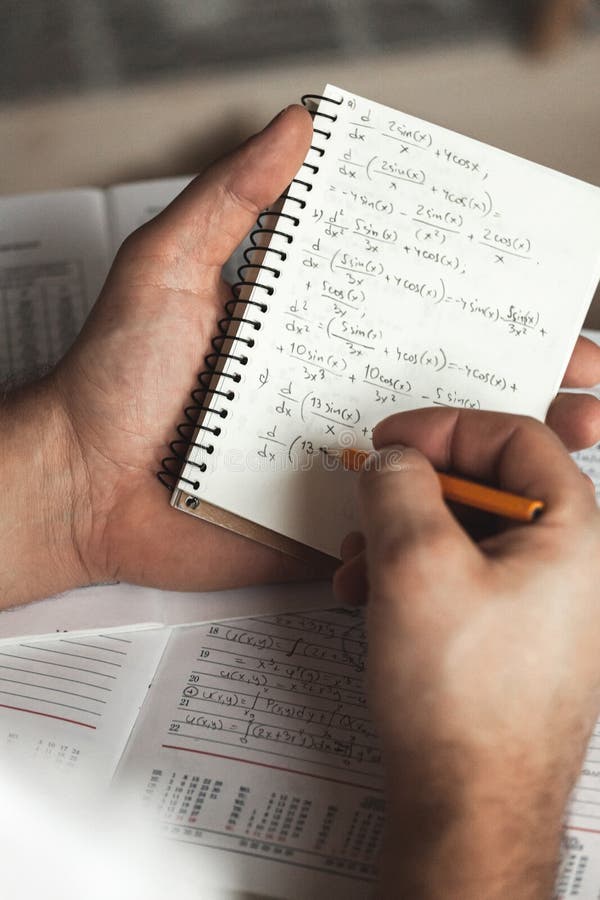 Math Formulas are Written in Pencil in a Notebook Holding Man in Stock ...