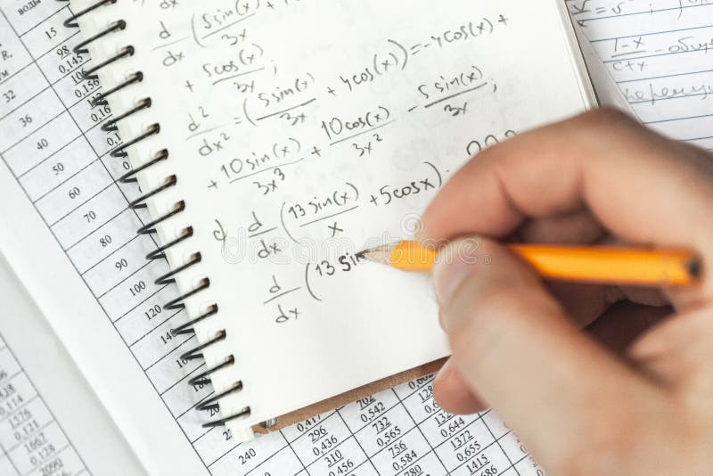 Math Formulas are Written in Pencil in a Notebook Holding Man in Stock ...