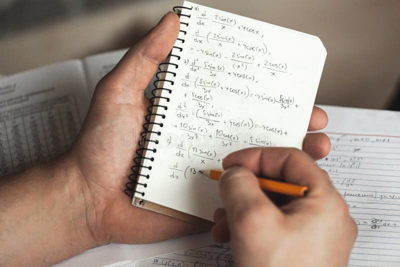 Math Formulas are Written in Pencil in a Notebook Holding Man in Stock ...