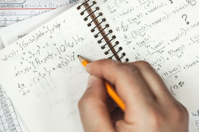 Math Formulas are Written in Pencil in a Notebook Holding Man in Stock ...