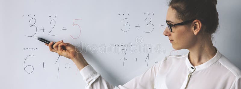 Math Lesson - Teacher Showing Simple Mathematical Equations on ...