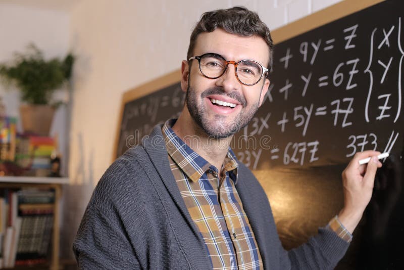 Math Teacher Writing with Chalk in Classroom Stock Image - Image of ...
