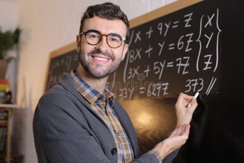 Math Teacher Writing with Chalk in Classroom Stock Photo - Image of ...