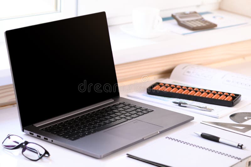 . Mathematical Courses. on the Table There is a Laptop and Supplies for ...