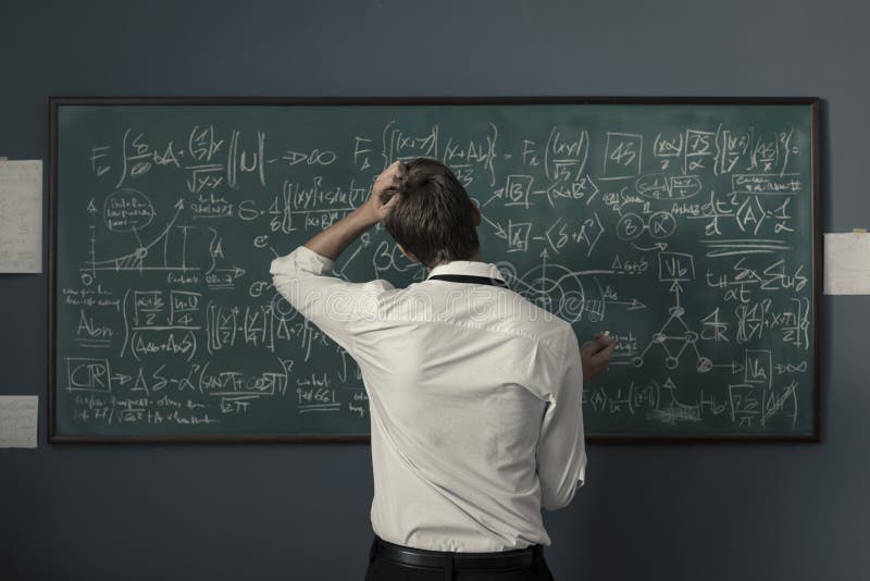 Mathematician Solving Problems and Writing Formulas on the Chalkboard ...