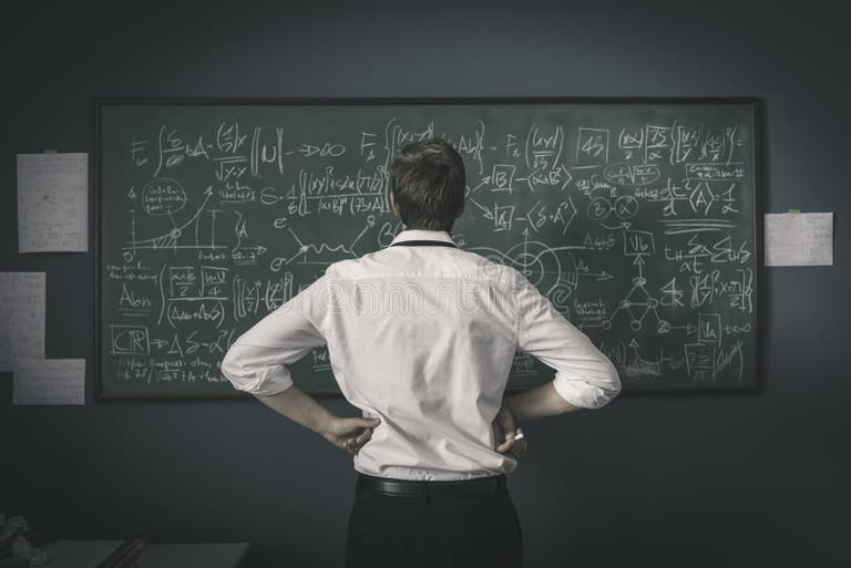 Mathematician Solving Problems and Writing Formulas on the Chalkboard ...