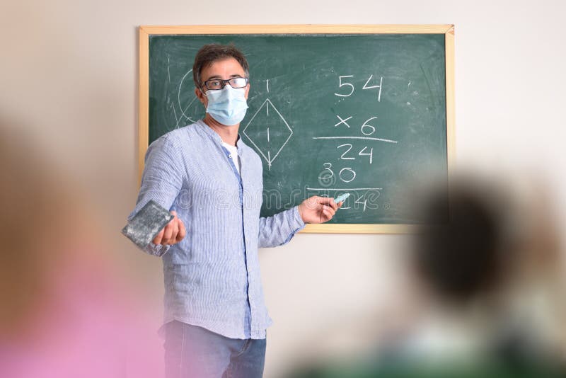 Mathematics Teacher Protected with Mask Explaining in Class Stock Photo ...