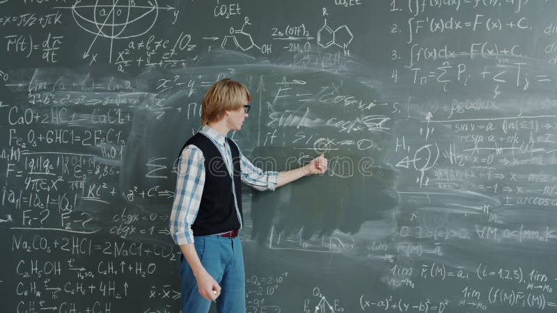 Maths Teacher Writing Formulas on Chalkboard Then Talking Teaching ...
