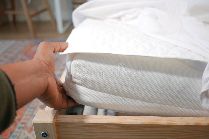 Mattress Being Adjusted in a Cozy Bedroom Setting Stock Photo - Image ...