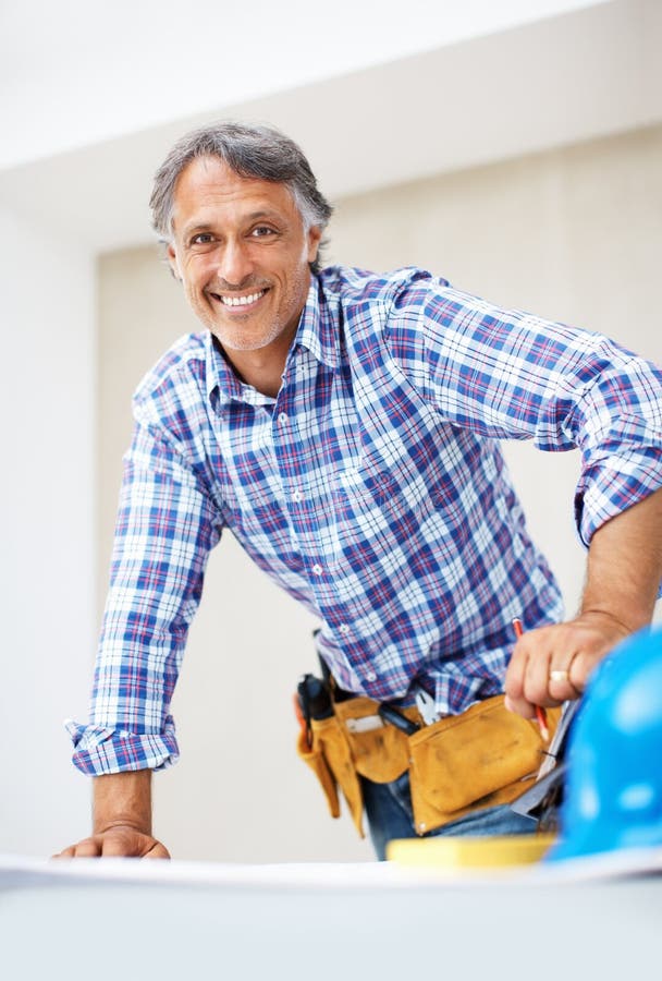 Mature Architect at Work. Mature Engineer Smiling while Working on Blue ... Mature Architect at Work. Mature Engineer Smiling while Working on Blue ...