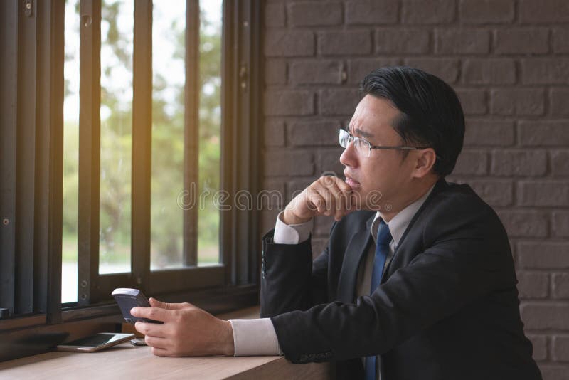 Mature Asian Businessman Thinking Business Plan in the Office Stock ...