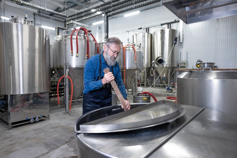Mature Bearded Factory Worker Stirring Beer in a Vat Stock Photo ...