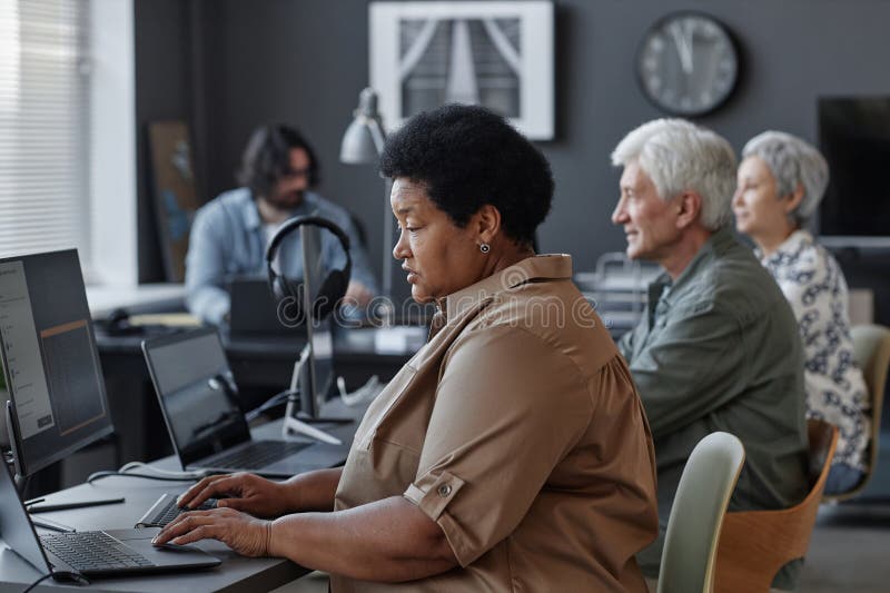 Senior People Using Computers in Row with Black Elderly Woman Typing ...
