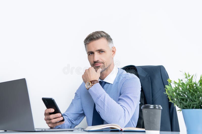 Mature Boss Working in Office with Smartphone and Laptop Stock Image ...
