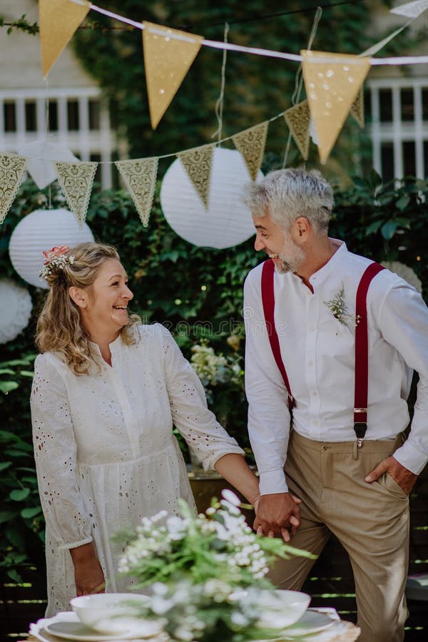 Mature Bride and Groom Having a Romantic Moment at Wedding Reception ...