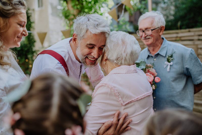 Mature Bride and Groom Receiving Congratulations at Wedding Reception ...