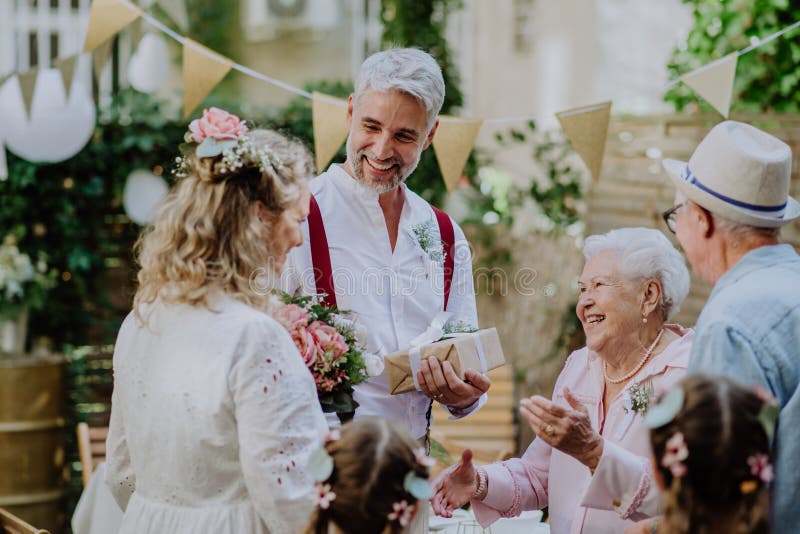 Mature Bride and Groom Receiving Congratulations at Wedding Reception ...
