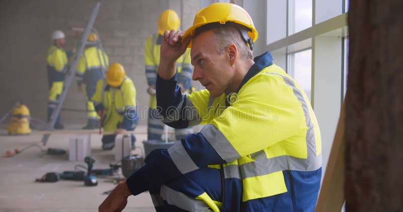 Mature Builder Relaxing at Construction Site during Break Stock Photo ...
