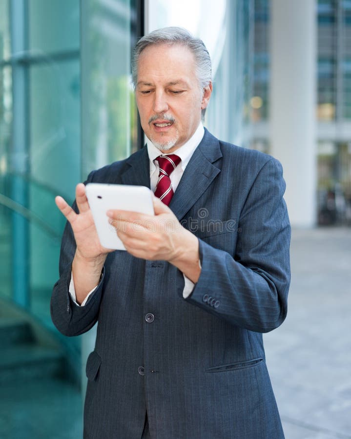 Mature Business Man Using a Tablet Stock Image - Image of network ...
