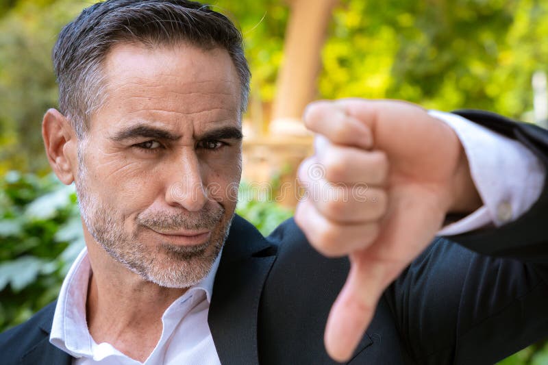 Mature Businessman Giving a Thumbs-Down Gesture Outdoors Stock Photo ...