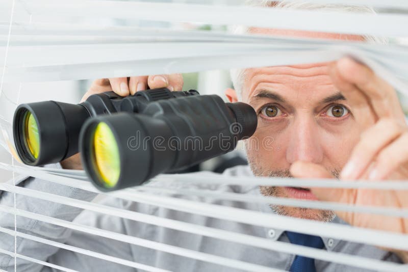 Mature Businessman Peeking with Binoculars through Blinds Stock Image ...