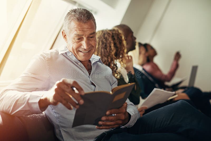 Mature Businessman Smiling while Reading Notes during an Office Stock ...