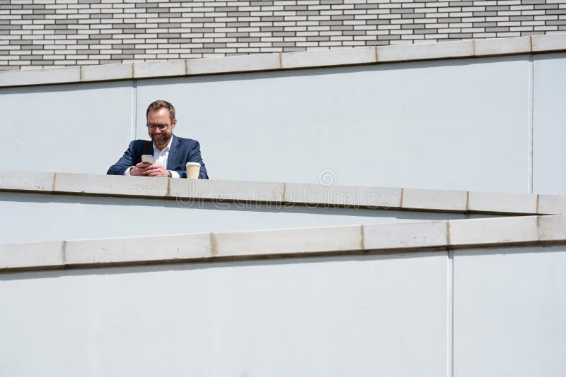 Mature Businessman Taking Phone Call on Mobile Phone Standing Outside ...