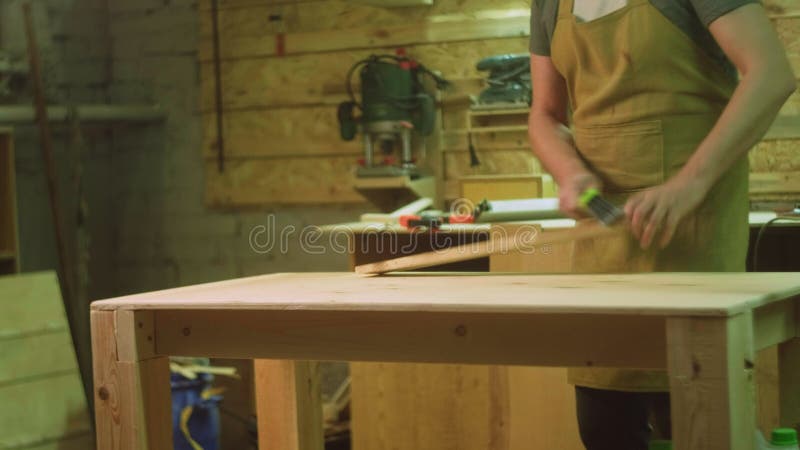 A Mature Carpenter Makes Works in His Carpentry Workshop, Measures the ...
