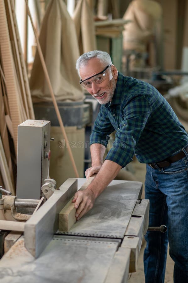 Mature Carpenter Working in a Worshop and Looking Involved Stock Image ...