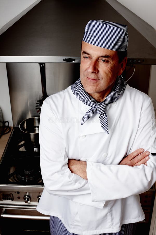 Mature Chef with Hands Folded Standing in Front of Vent Hood. Portrait ...