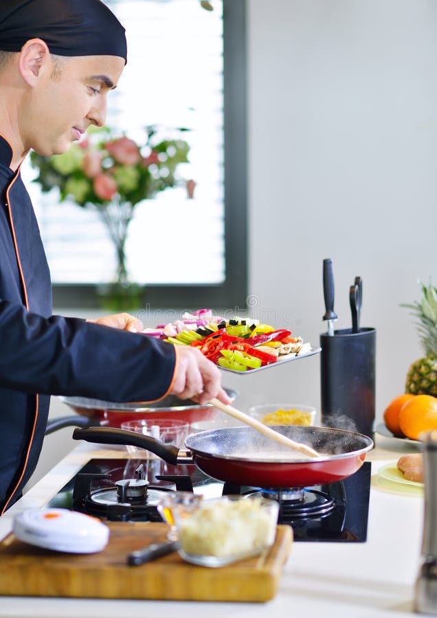 Mature Chef Preparing a Meal with Various Vegetables and Meat Stock ...