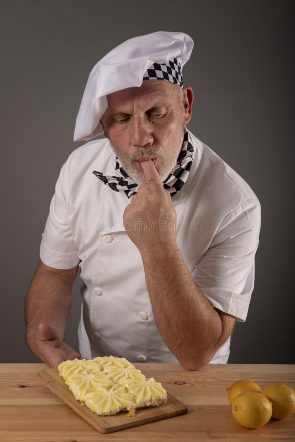 Mature Chef Tasting a Lemon Cake Stock Image - Image of taste, male ...