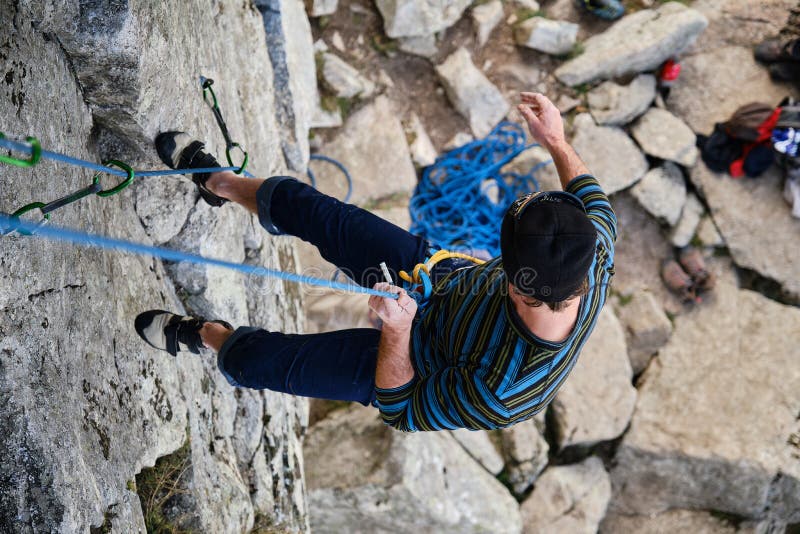 A Mature Climber Descending the Rope on the Rock Wall. Stock Image ...