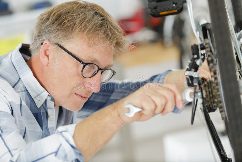 Mature Competent Bicycle Mechanic in Workshop Stock Image - Image of ...