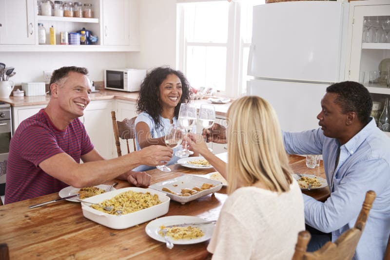 Mature Couple Entertaining Friends at Dinner Party Stock Photo - Image ...